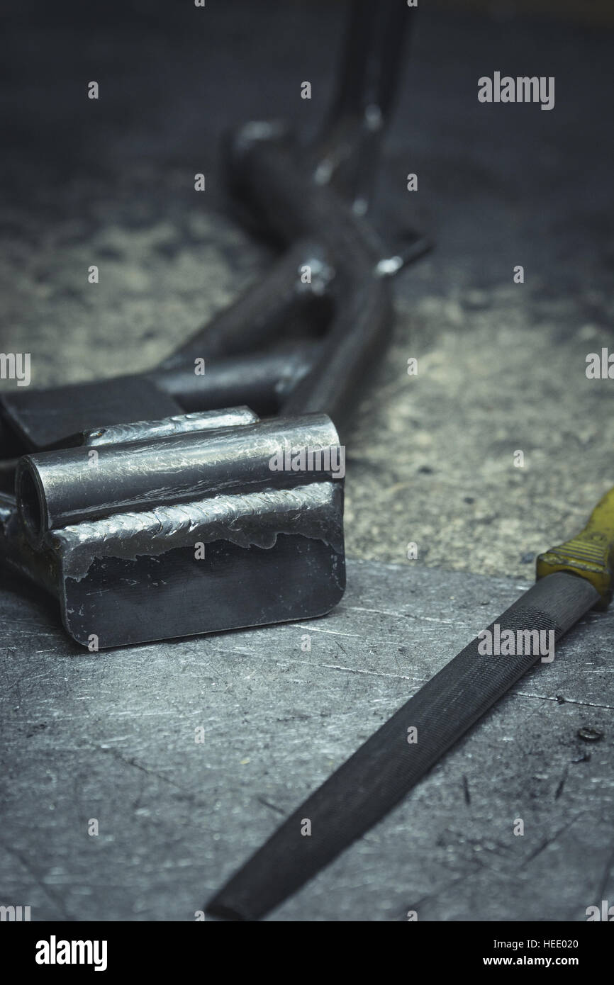 Steel pipe products and metal file on a working table Stock Photo - Alamy