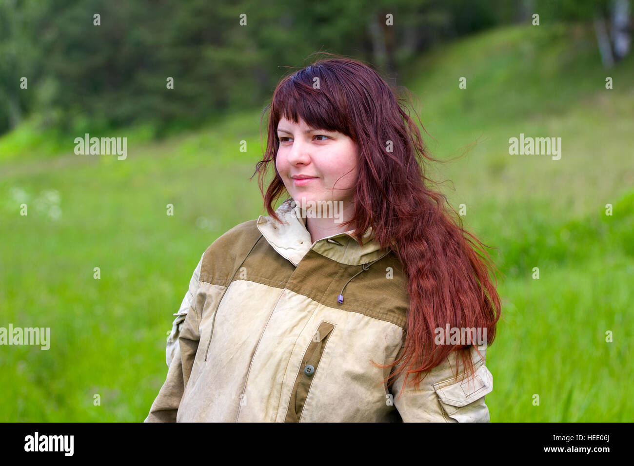 girl in jacket fireman old style. in overalls outside city among ...