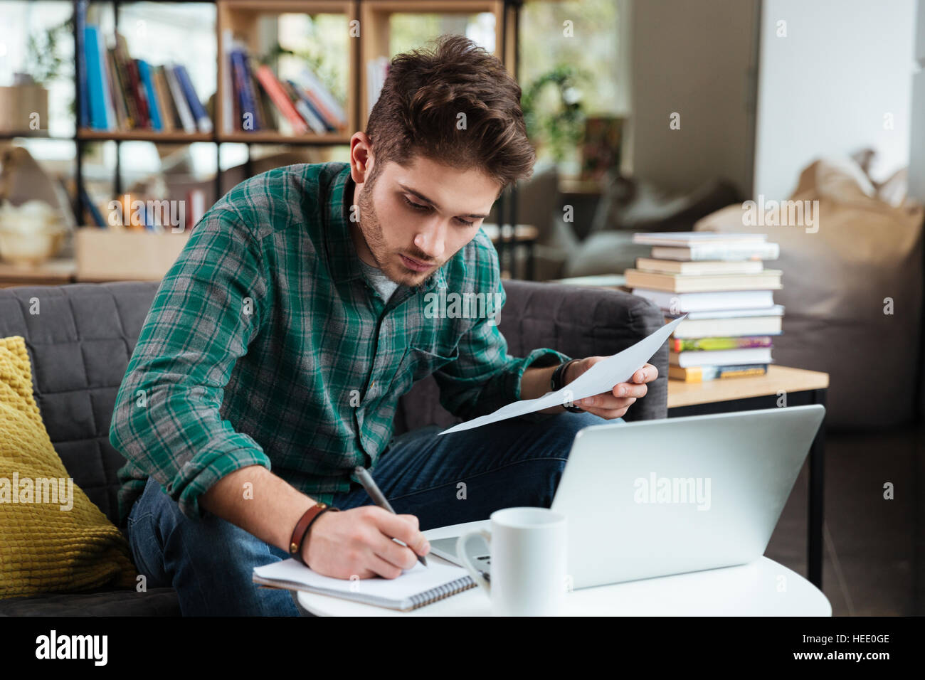 Man writing on documents sitting hi-res stock photography and images ...