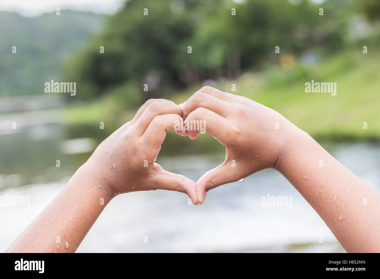 Close up wet hands with heart sign at the river in Thailand Stock Photo ...