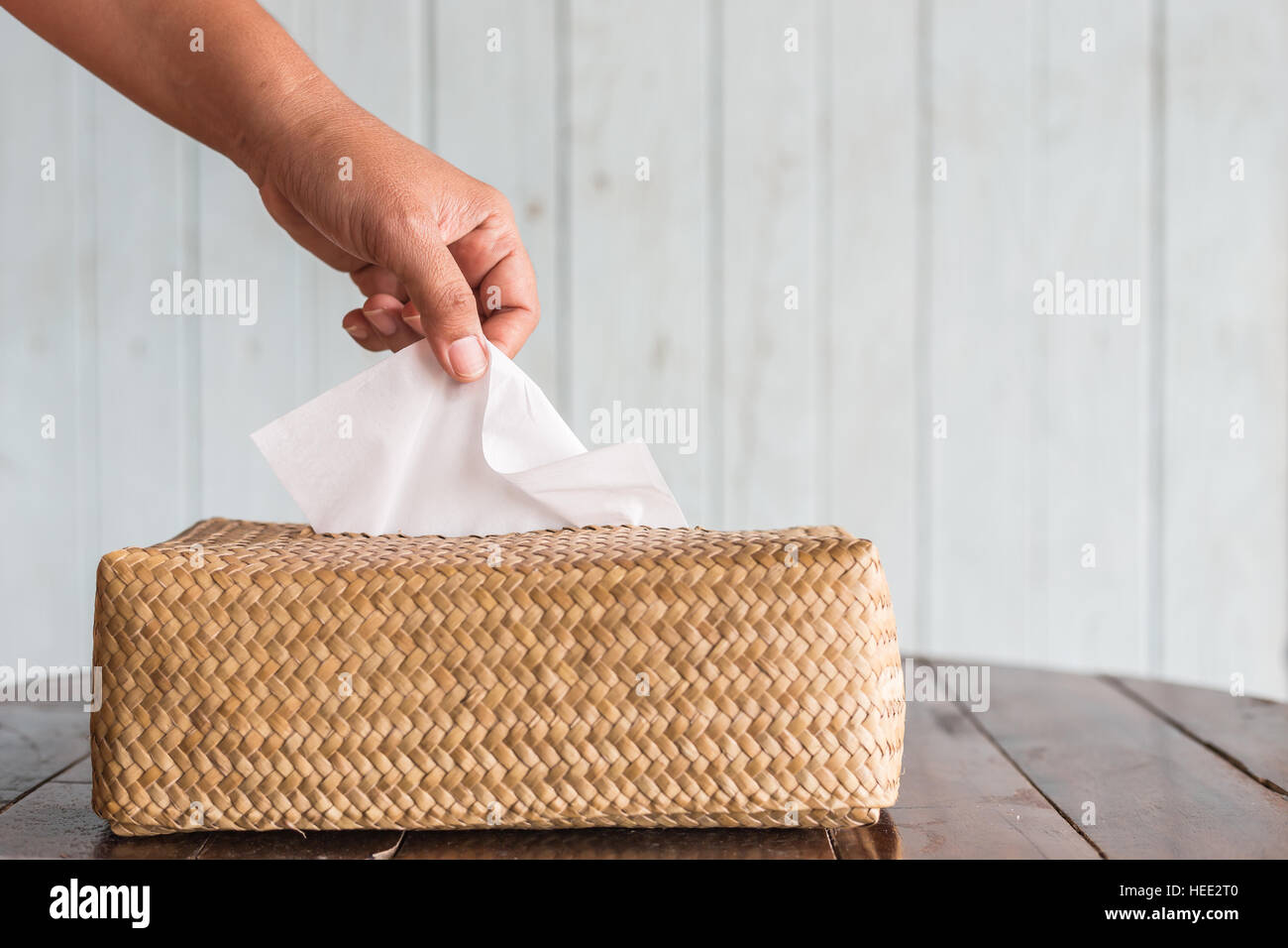 Hand picking white piece tissue paper from brown box Stock Photo - Alamy