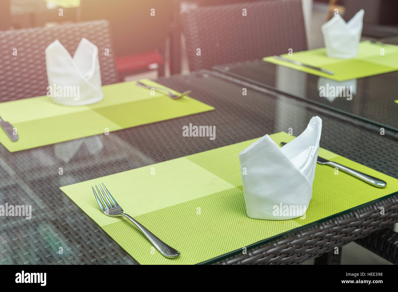 Set of fork and knife on glass table in the restaurant Stock Photo - Alamy