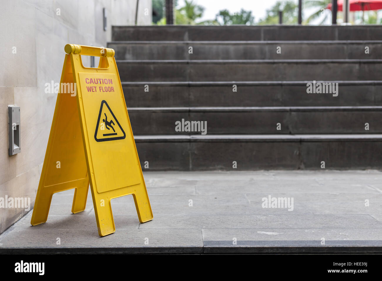 Yellow wet floor warning sign on the floor in hotel corridor Stock ...