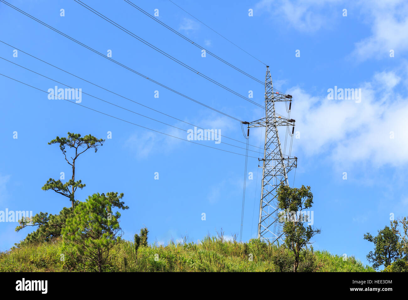 High voltage electric tower on the mountain and blue sky background ...