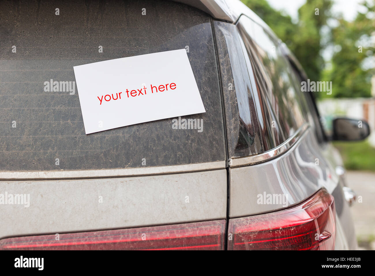 Close up backside of dirty car with empty paper for text. Car wash ...