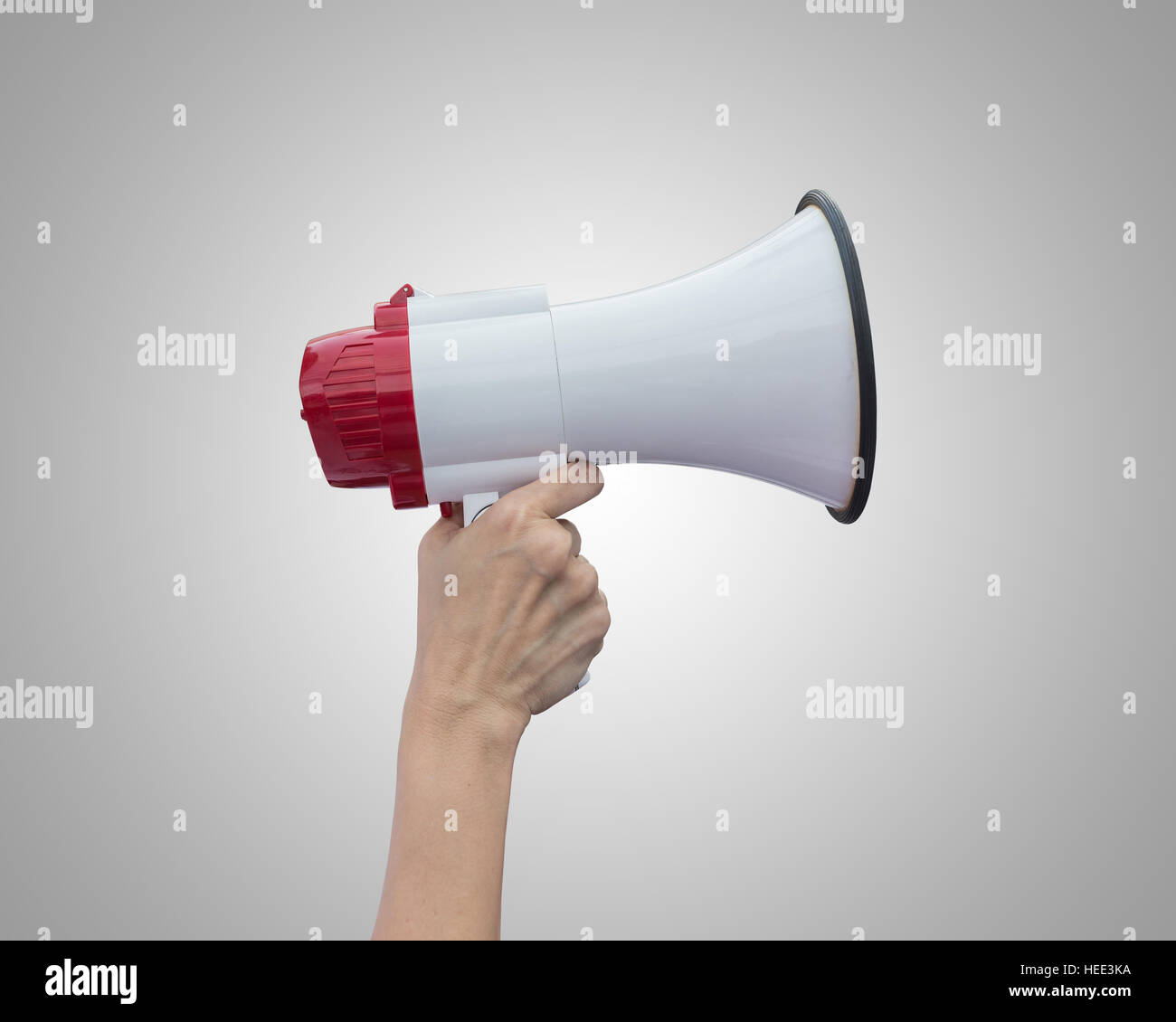 Right hand holding white megaphone isolated on grey background. Saved ...