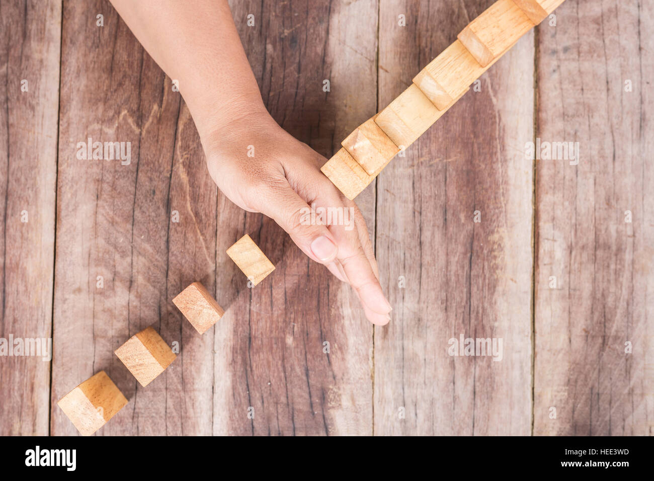 Close up hand stop wooden block. Domino risk effect concept Stock Photo ...