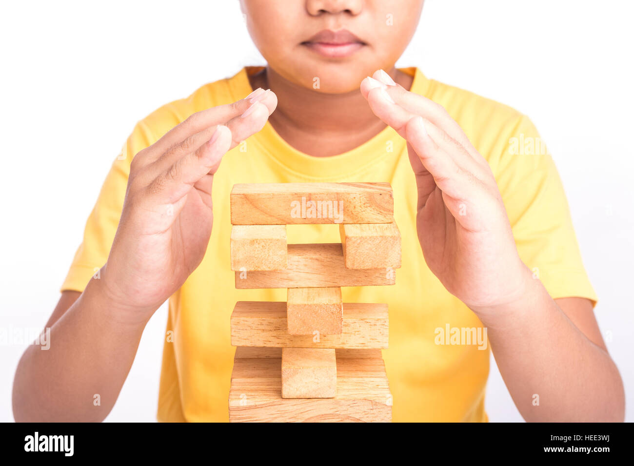 Close up children hand protect blocks wood game (jenga) isolated on ...