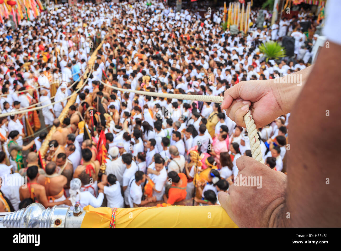 Hand pull on rope in perform a ceremony set the sacred wood poles is ...