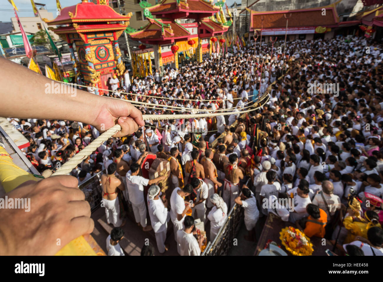 Hand pull on rope in perform a ceremony set the sacred wood poles is ...