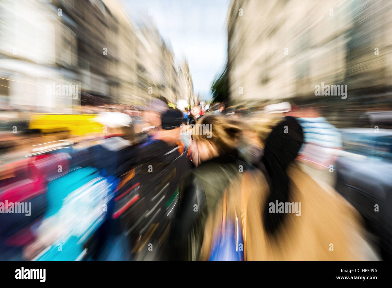 picture with zoom effect of crowds of pedestrians walking in the city ...