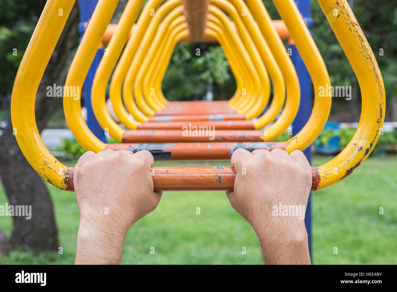 Close up hand hanging on steel bar for trapeze. Outdoor exercise ...