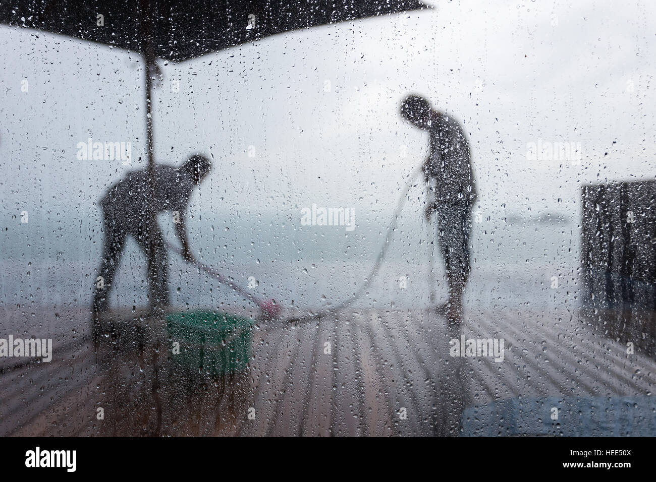 Abstract of blurred people washing decking by pressure wash. Focus on ...