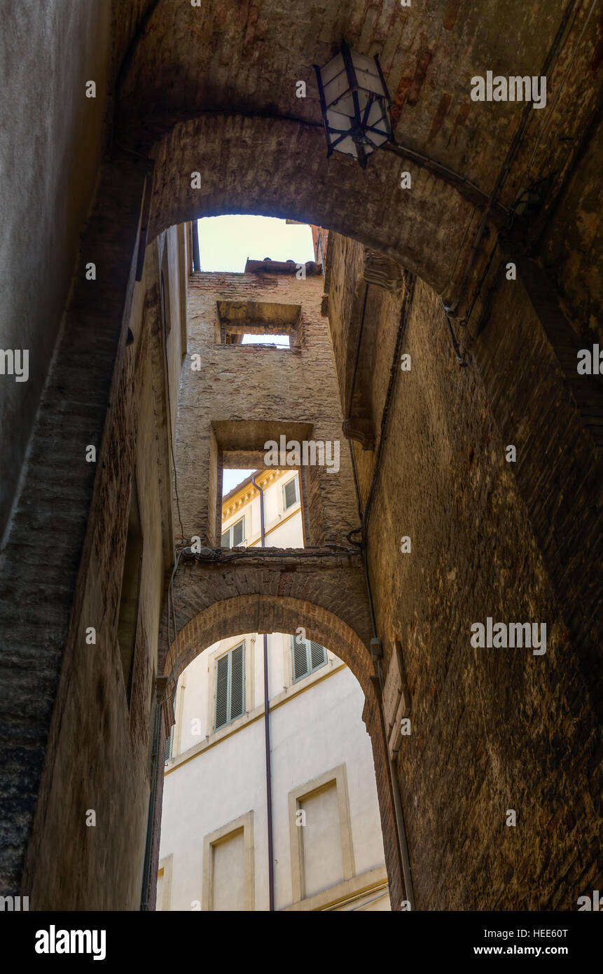 arches between historical buildings in Siena, Tuscany, Italy Stock ...