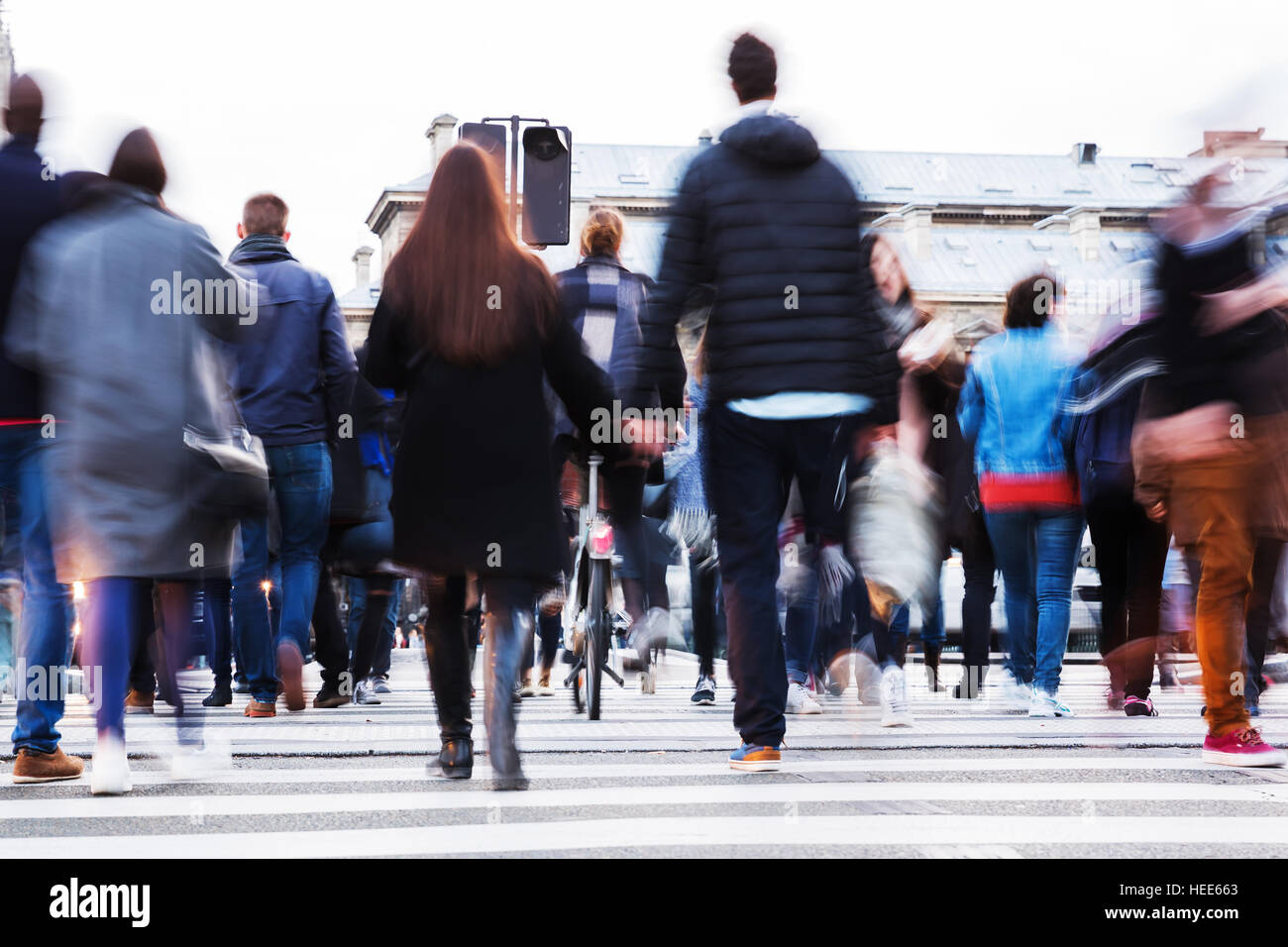 crowds of people in motion blur crossing a city street Stock Photo - Alamy