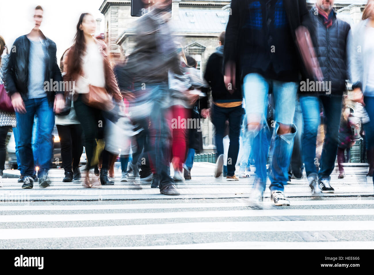 crowds of people in motion blur crossing a city street Stock Photo - Alamy