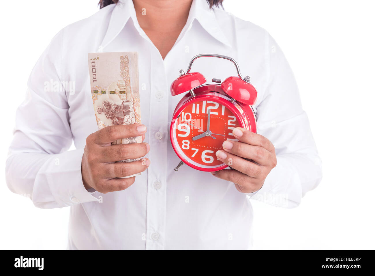 Woman holding Thai money and red alarm clock isolated on white ...