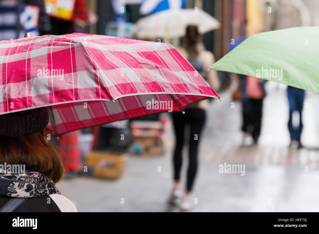 people with rain umbrella in the rainy city Stock Photo - Alamy