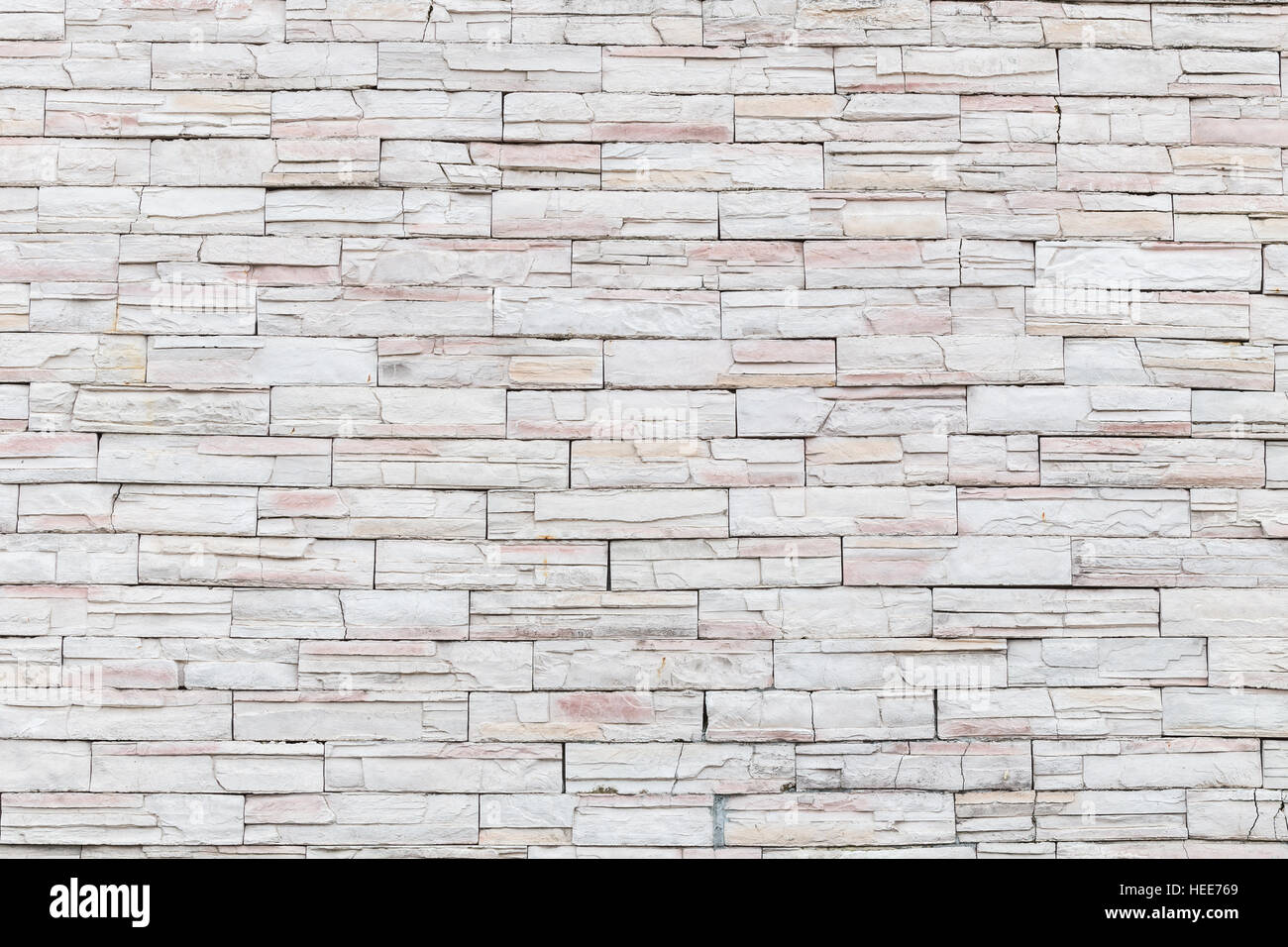 Pattern of white natural stone wall and flower plant. Garden decorative ...