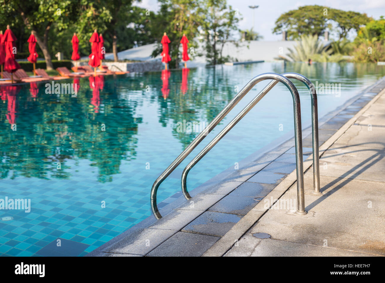 Outdoor swimming pool with shiny stainless steel stair Stock Photo - Alamy