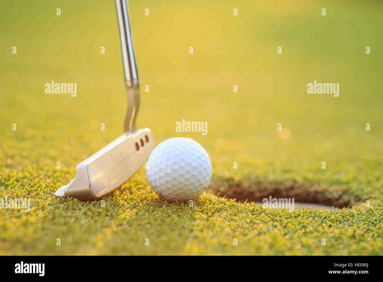 Close up golf ball on lip of cup in course Stock Photo - Alamy