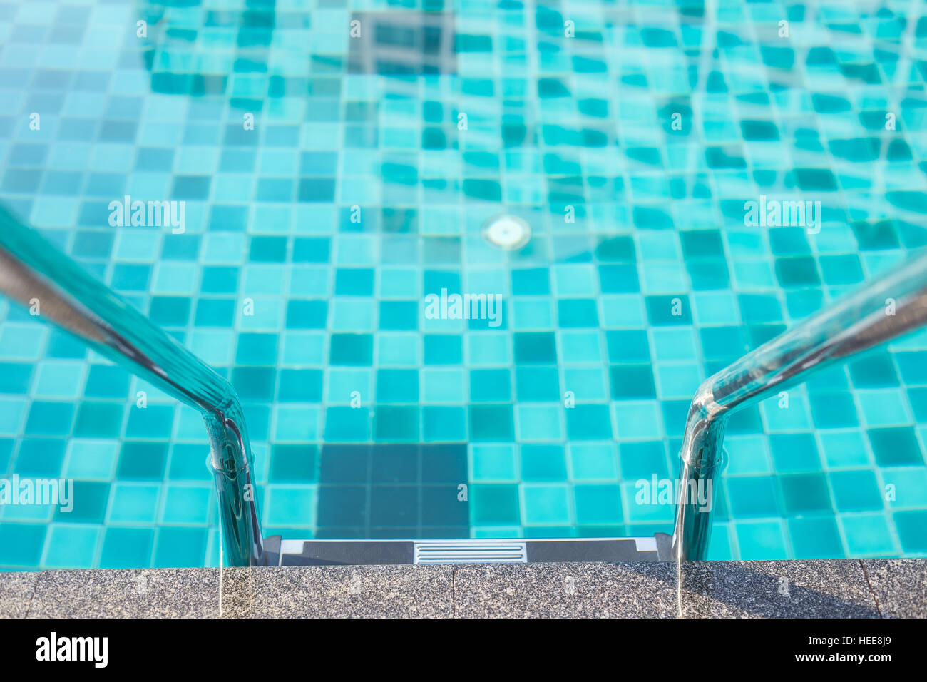Outdoor swimming pool with shiny stainless steel stair Stock Photo - Alamy