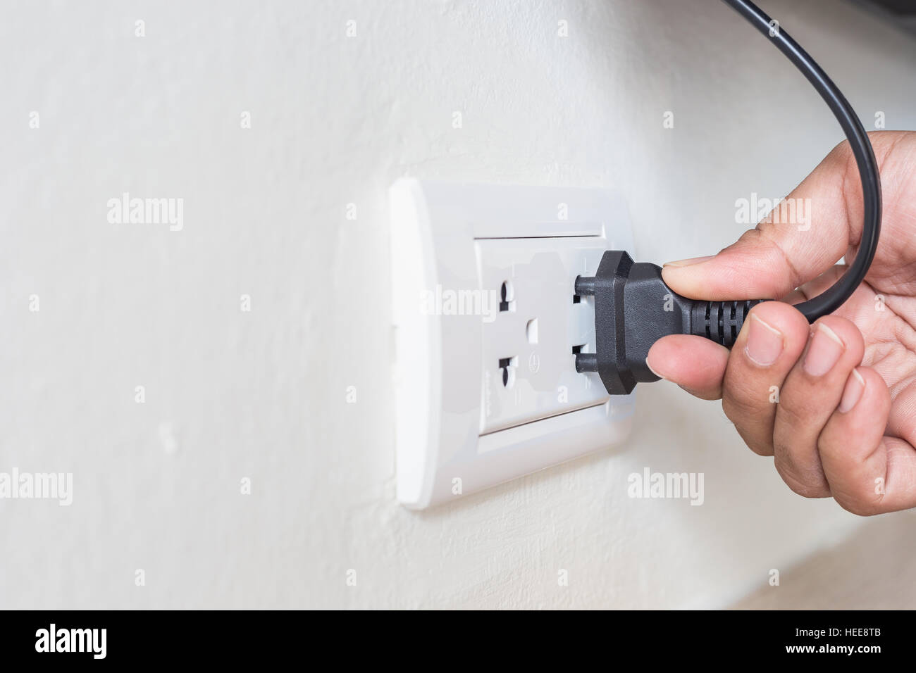 Close up unplug or plugged in concept,hand holding and pull electric ...