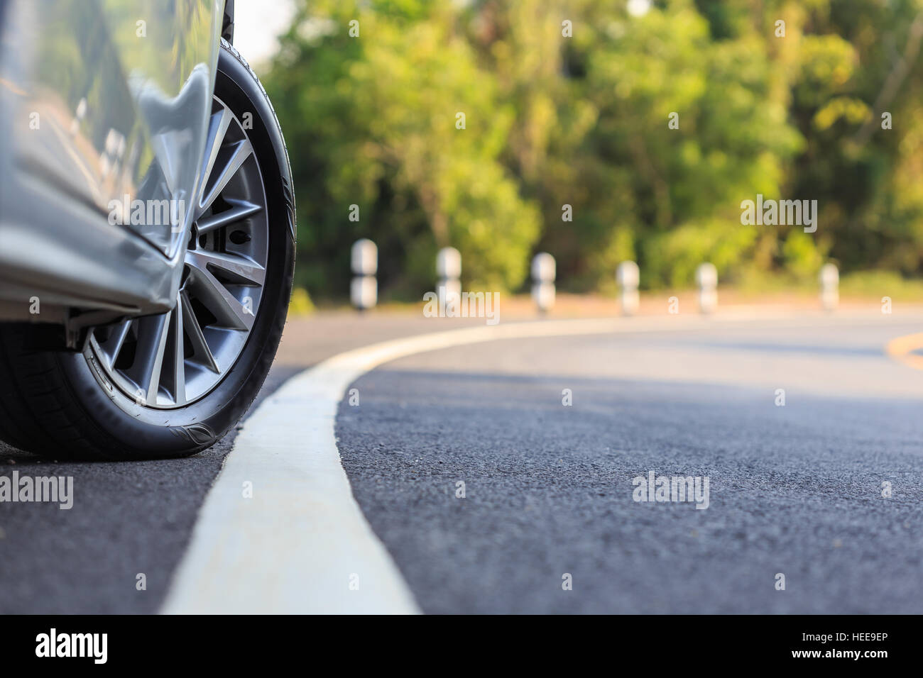 Close up front car wheel on the asphalt road Stock Photo - Alamy