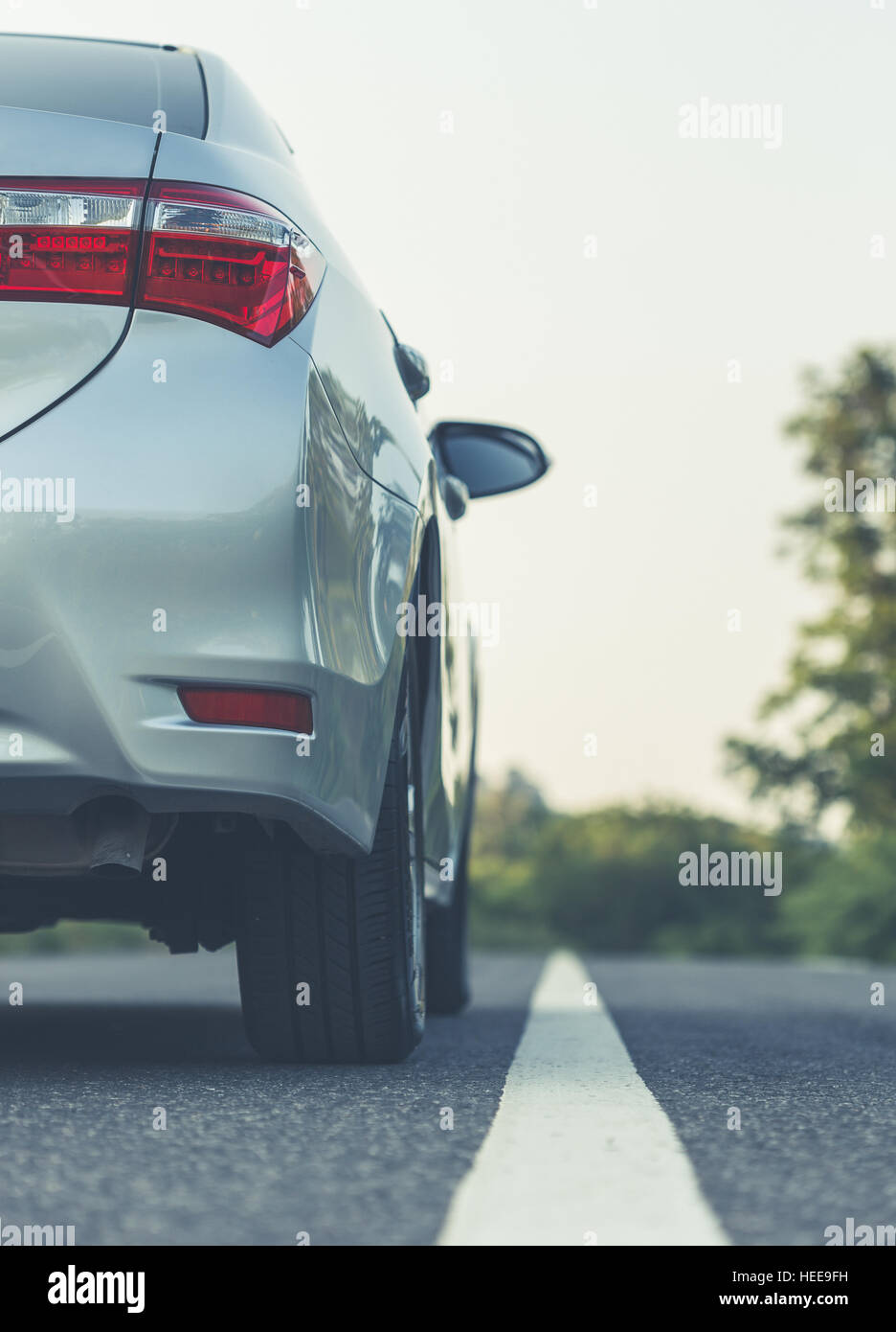 Close up back side of new silver car parking on the asphalt road Stock ...