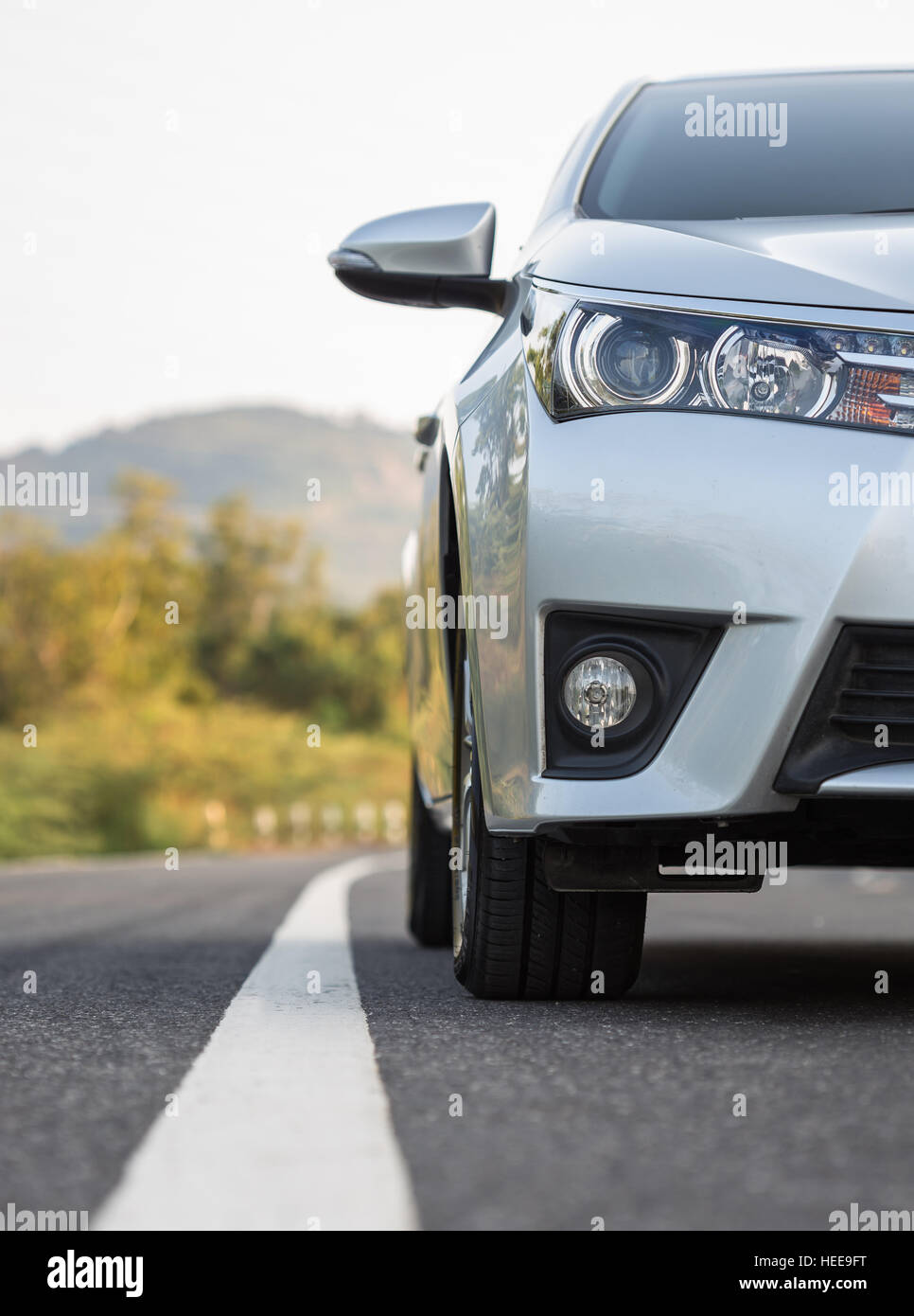 Close up front of new silver car parking on the asphalt road Stock ...