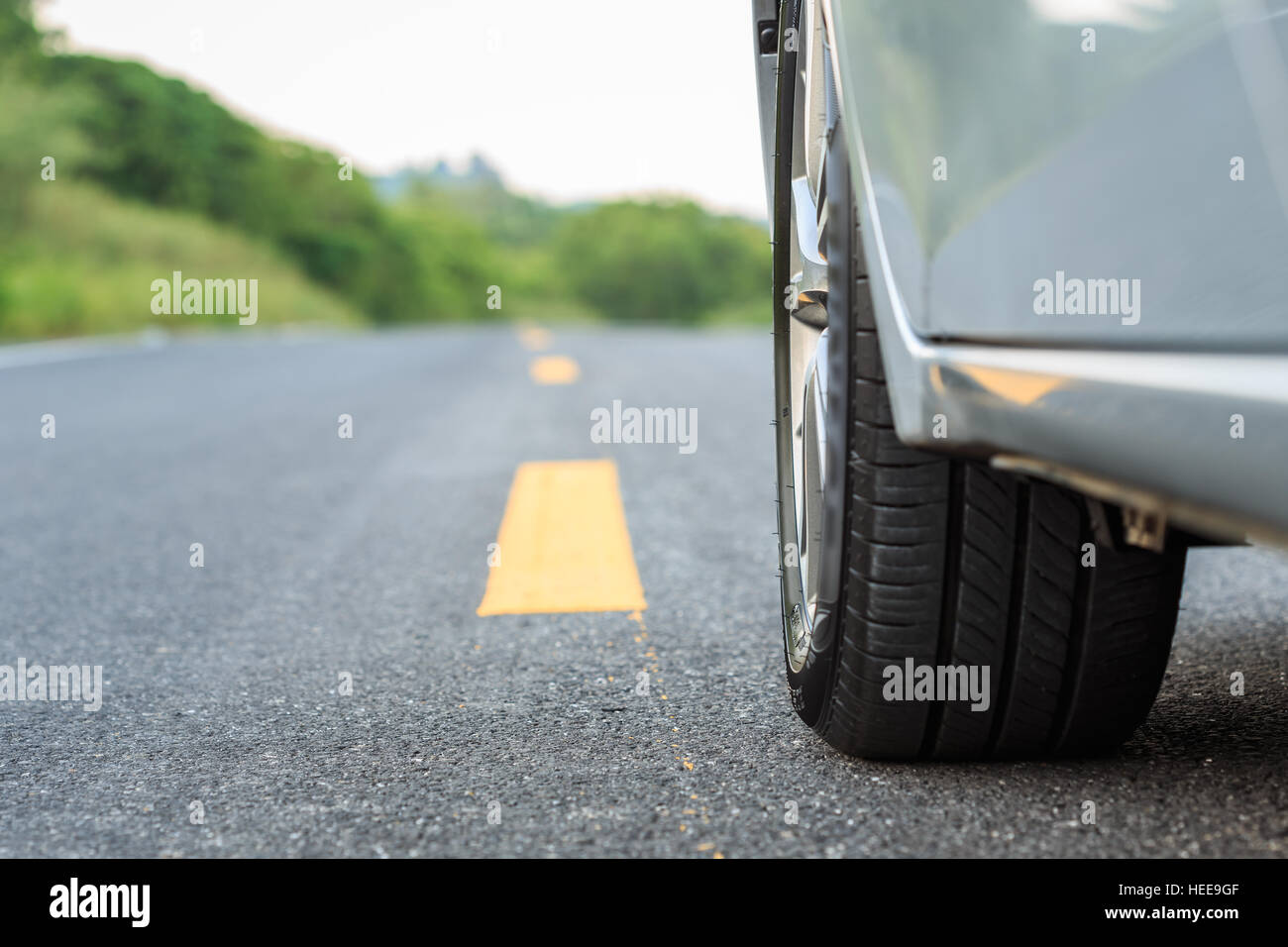 Close up front car wheel on the asphalt road Stock Photo - Alamy