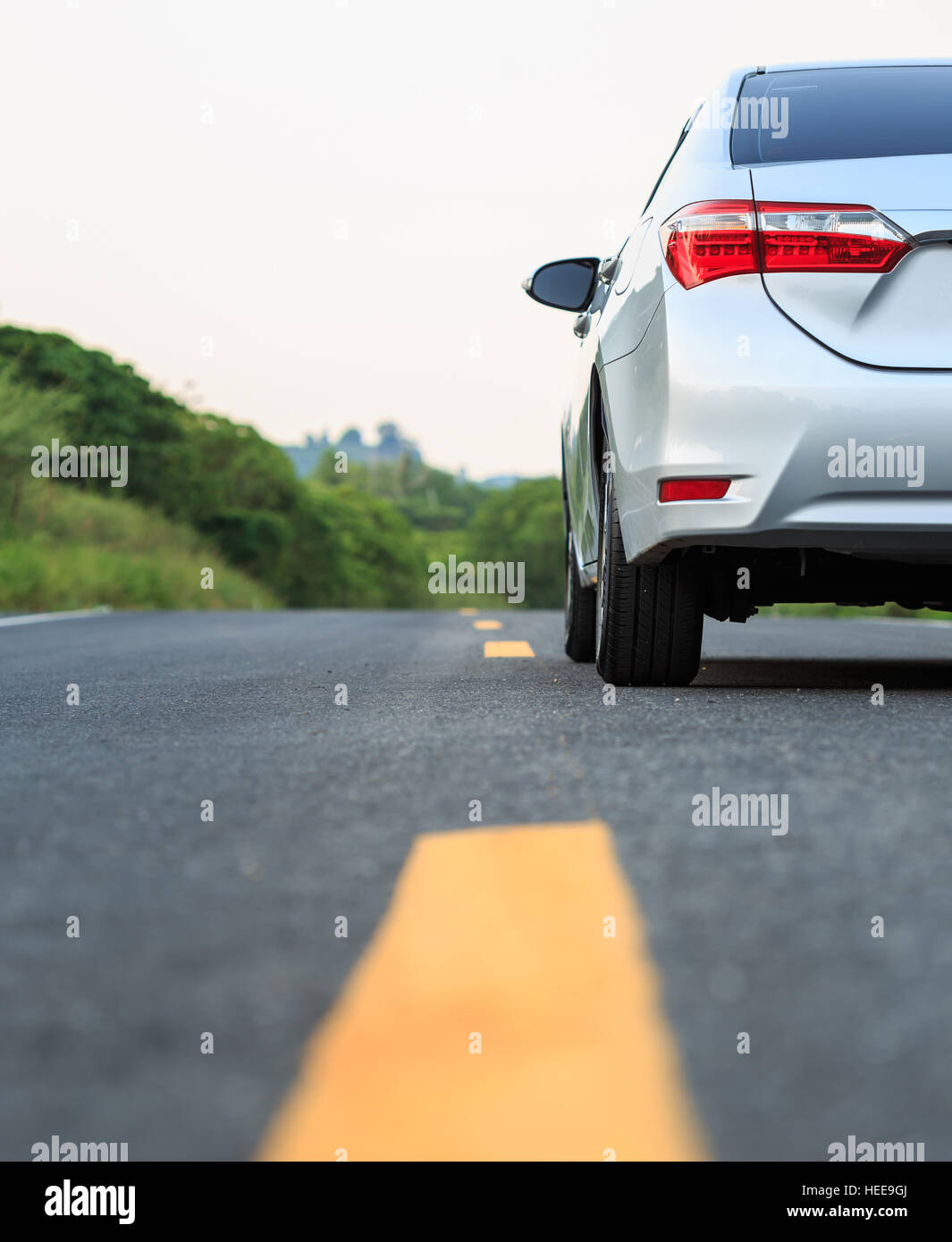 Close up back side of new silver car parking on the asphalt road Stock ...