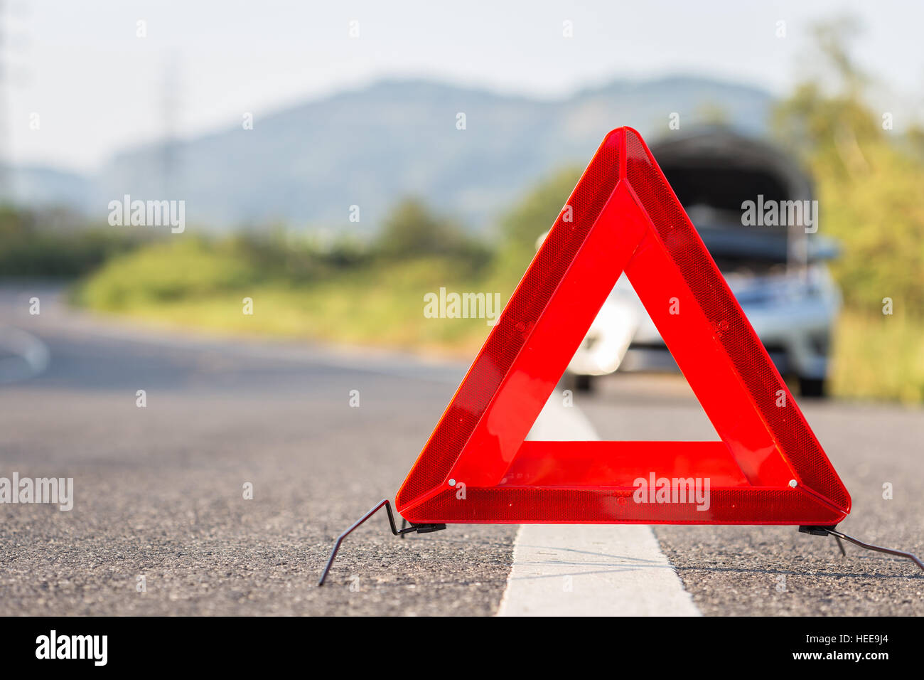 Red emergency stop sign and broken silver car on the road Stock Photo ...