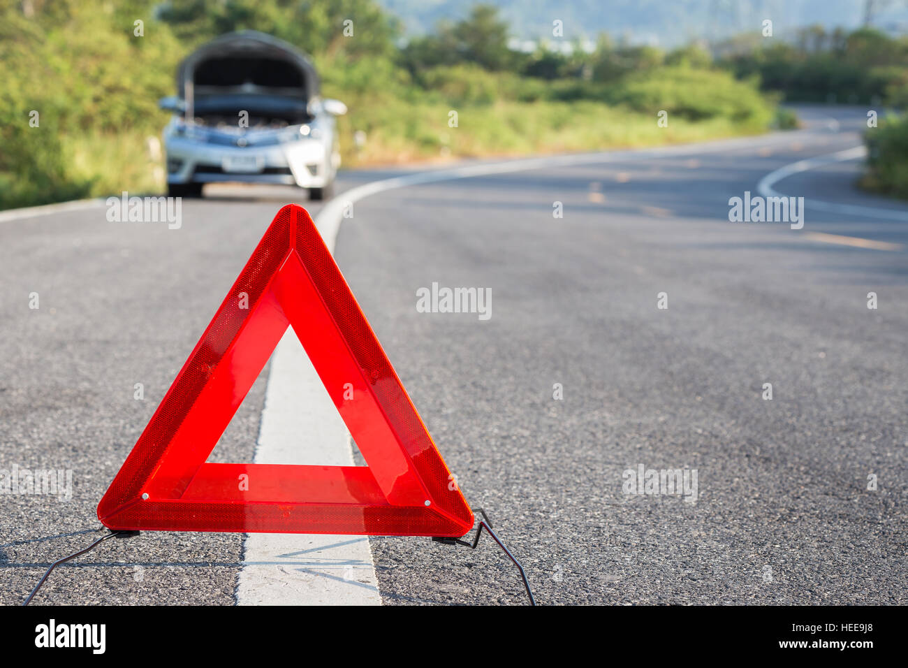 Red emergency stop sign and broken silver car on the road Stock Photo ...