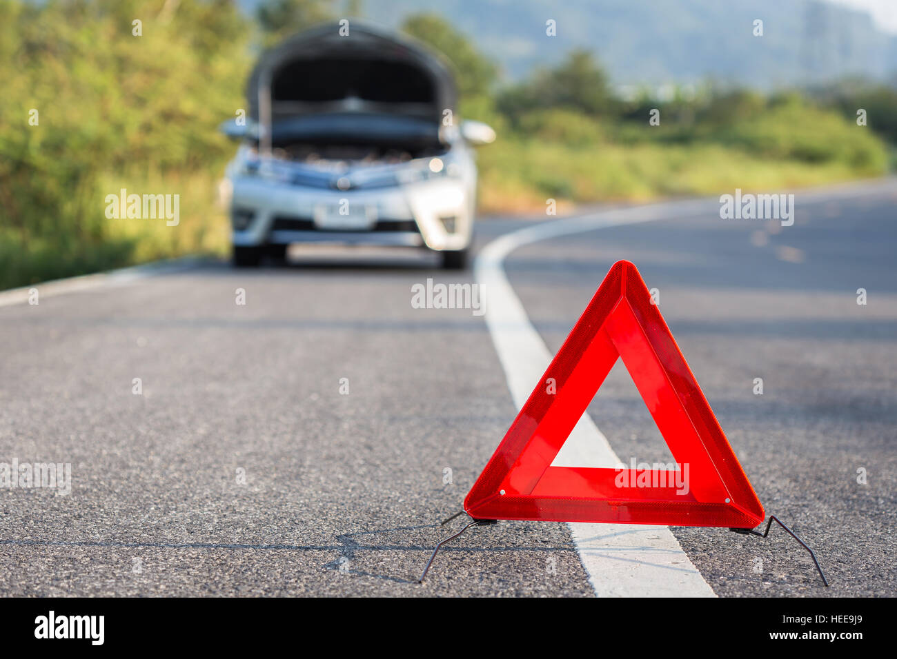 Red emergency stop sign and broken silver car on the road Stock Photo ...