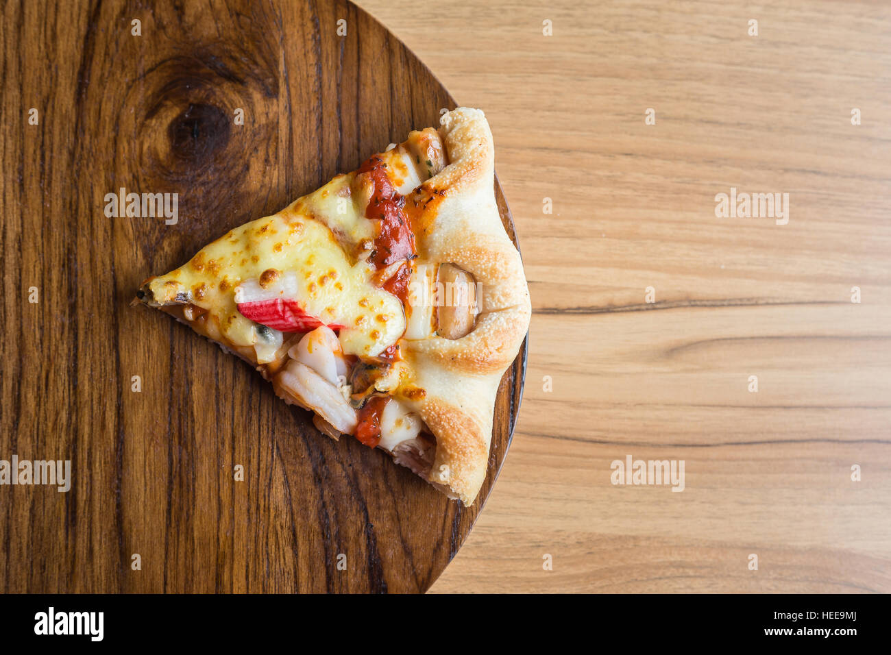 Close up pizza on wooden plate on top table background Stock Photo - Alamy