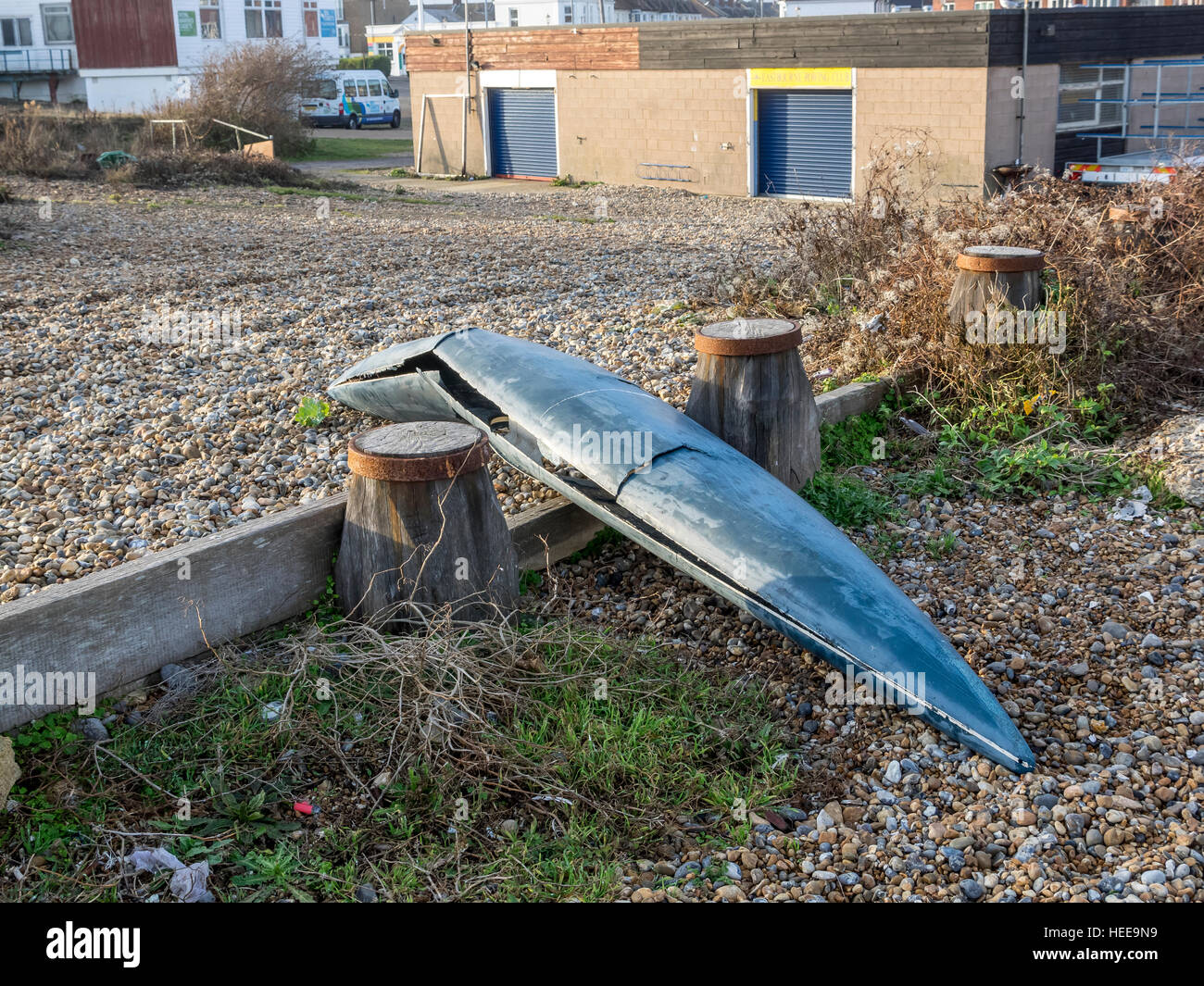 Broken canoe laying across a break water on the East beach Eastbourne ...