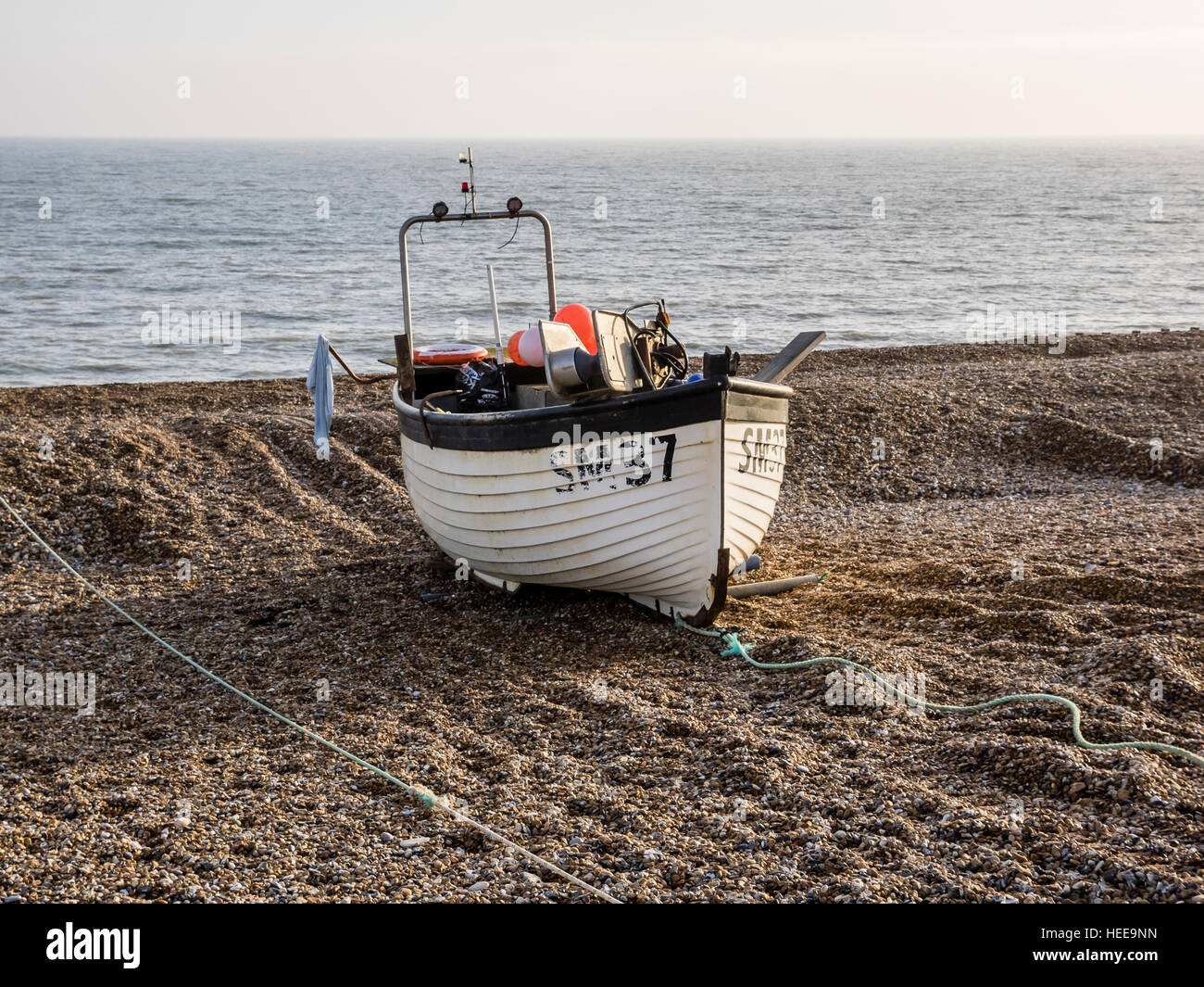 Beached fishing boat in late evening Stock Photo - Alamy