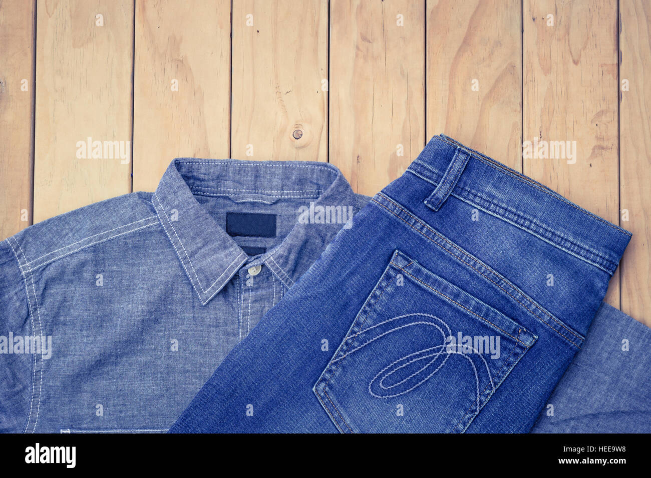 New blue jeans on wooden background top view Stock Photo - Alamy