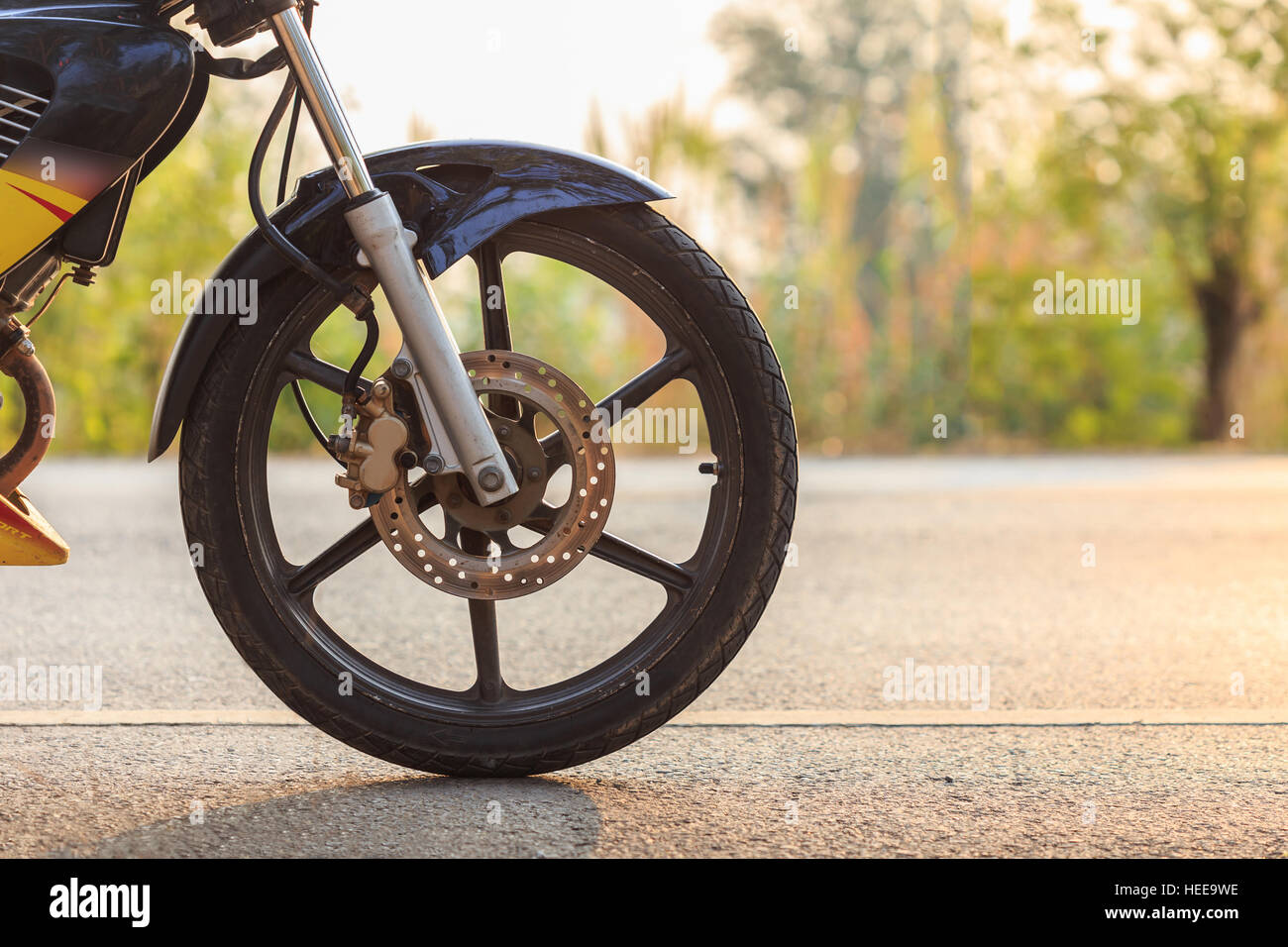 Close up front wheel of motorbike on asphalt road Stock Photo - Alamy