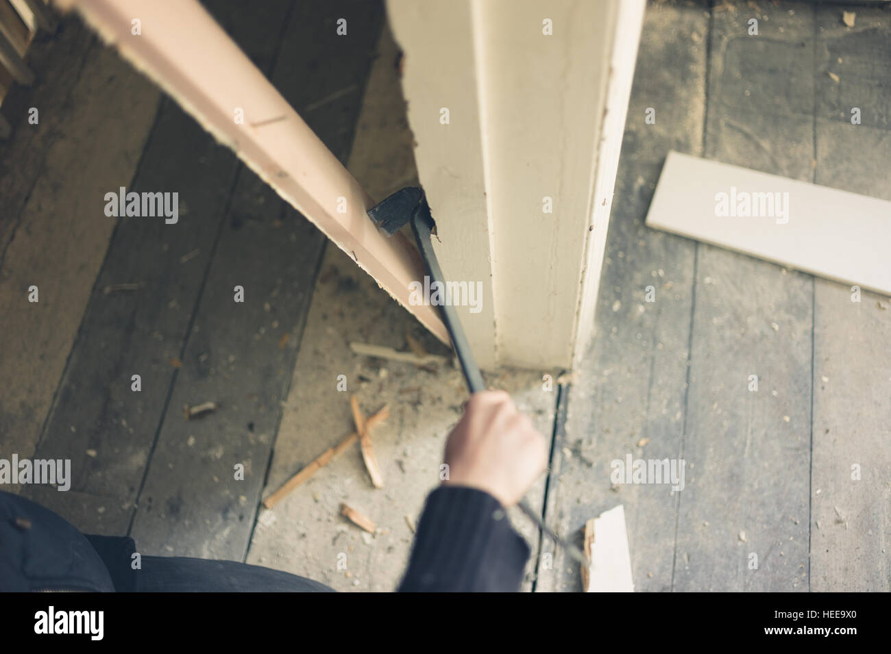 Close up on a worker's hand breaking a door frame with a crowbar Stock ...