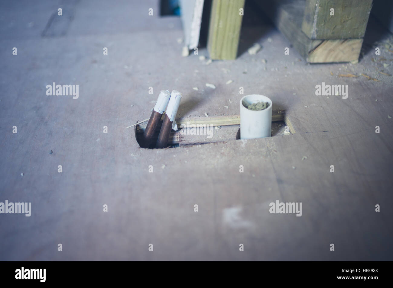Pipes and plumbing in the floor for a bath Stock Photo - Alamy