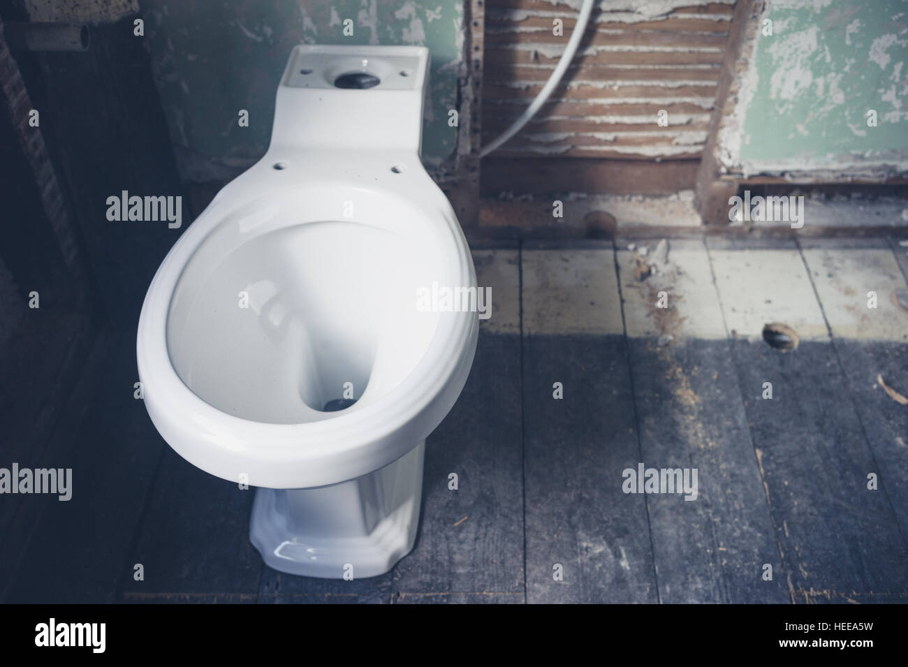 A brand new toilet fitted in an old derelict room being converted to a ...