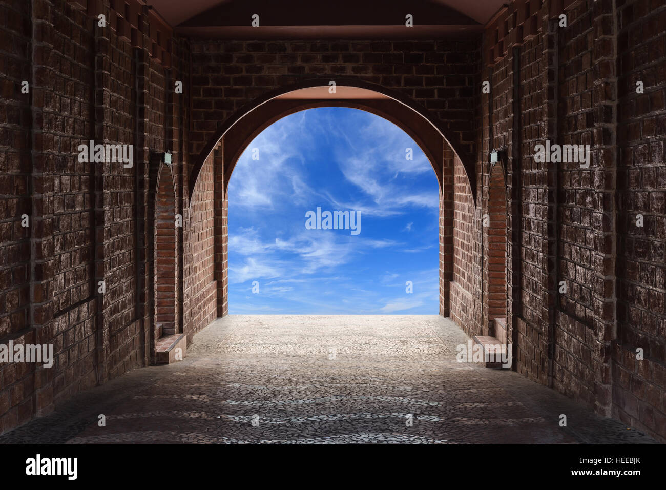 Walkway tunnel made by red brick and view of blue sky with cloud Stock ...
