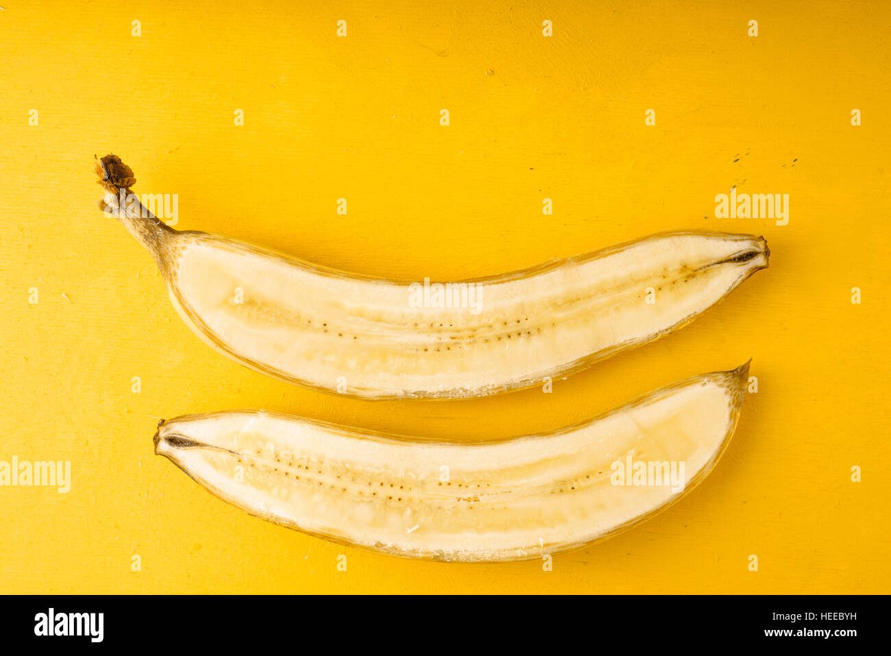 Halved yellow banana on the table horizontal Stock Photo - Alamy
