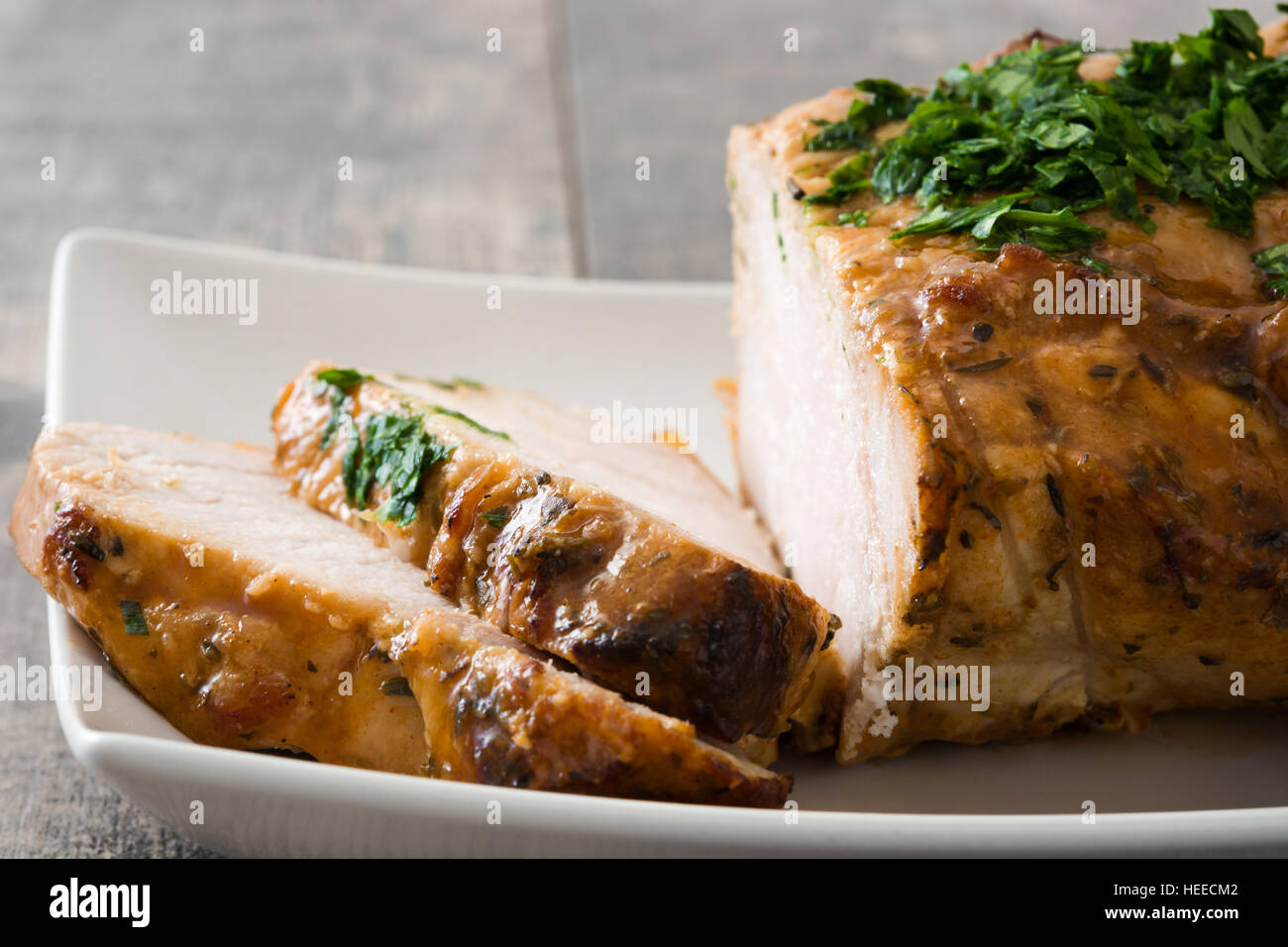 Roasted pork on wooden table Stock Photo - Alamy