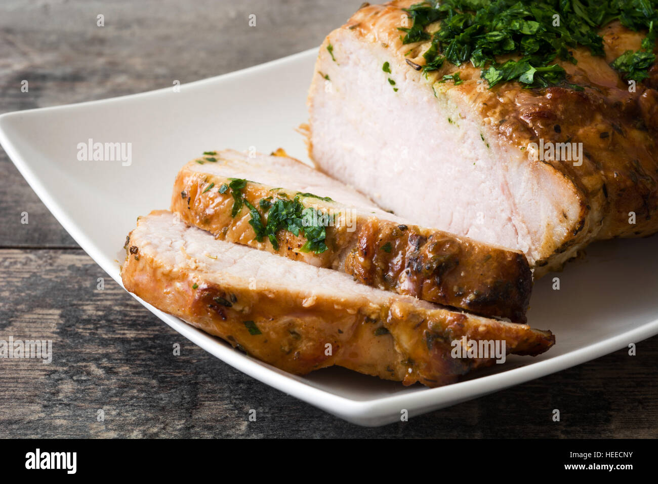 Roasted pork on wooden table Stock Photo - Alamy