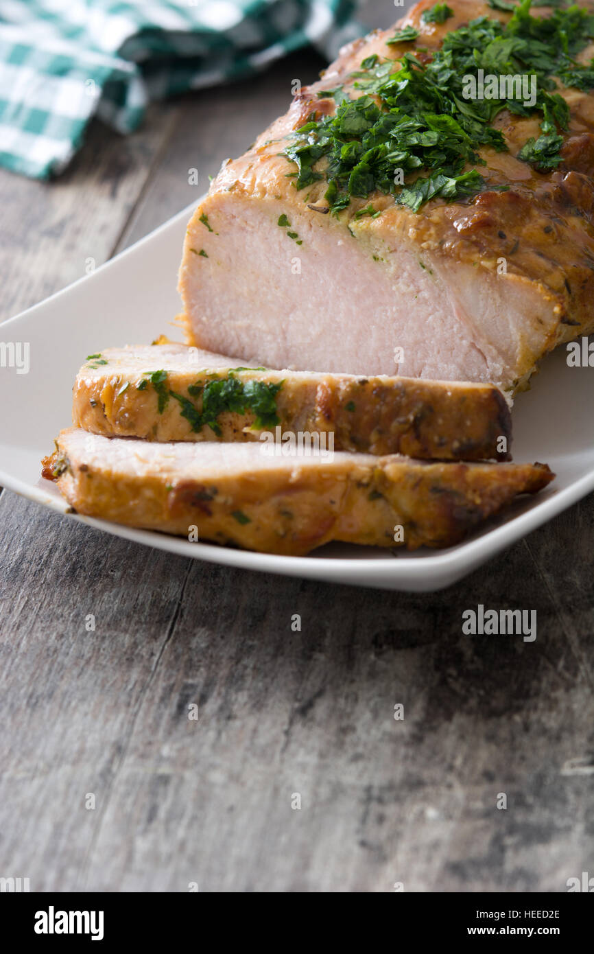 Roasted pork on wooden table Stock Photo - Alamy