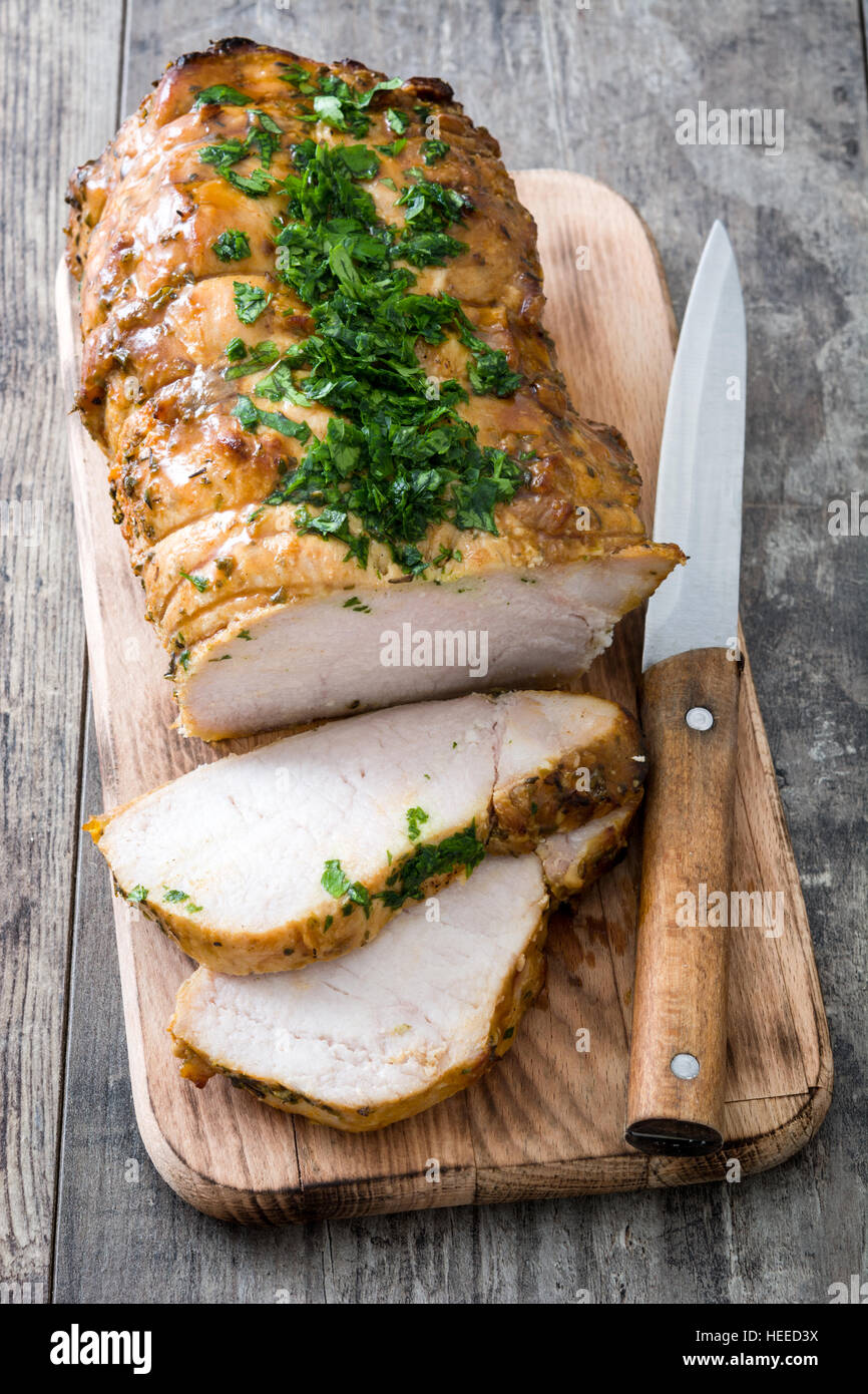Roasted pork on wooden table Stock Photo - Alamy
