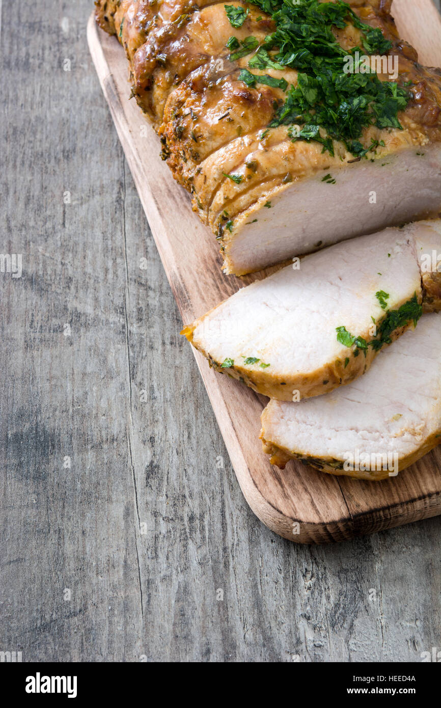 Roasted pork on wooden table Stock Photo - Alamy
